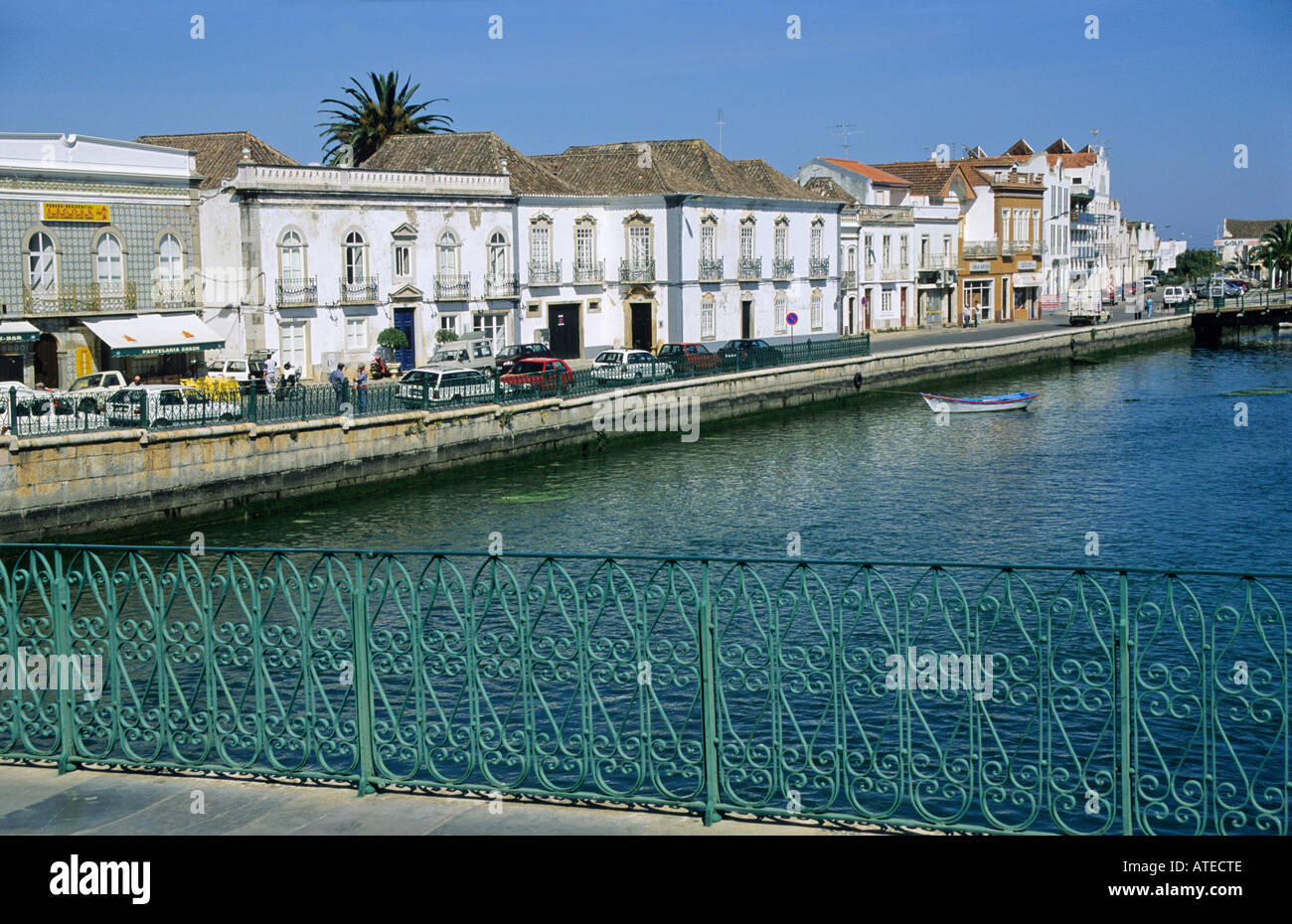 A view over the River Gilao where wrought iron railings mirror the ...