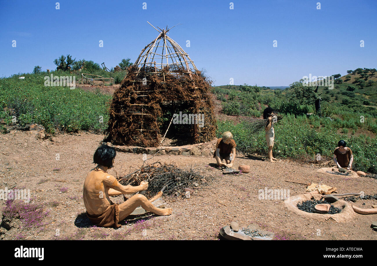 Models dressed as prehistoric men with prehistoric huts as part of a ...