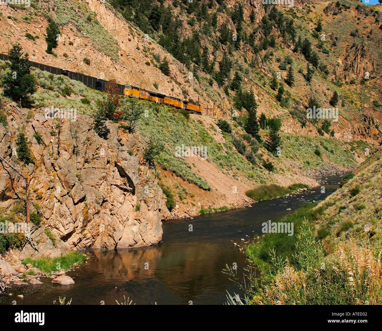 A train travels along the Colorado River through a mountain pass near ...