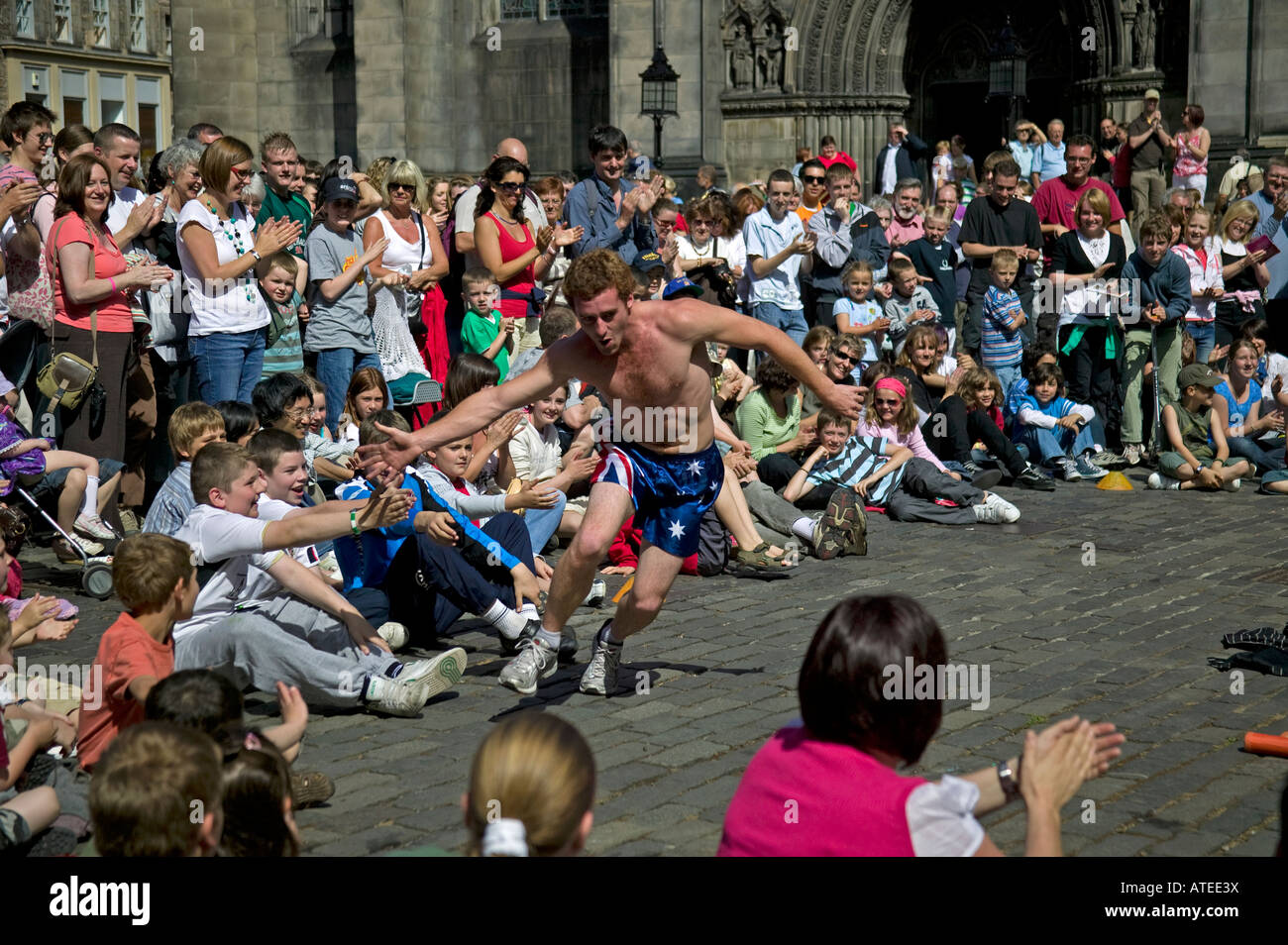 Street Performer races along audience line slapping hands, Edinburgh ...