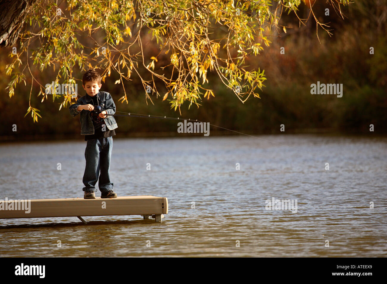 Boy fishing off dock in hi-res stock photography and images - Alamy