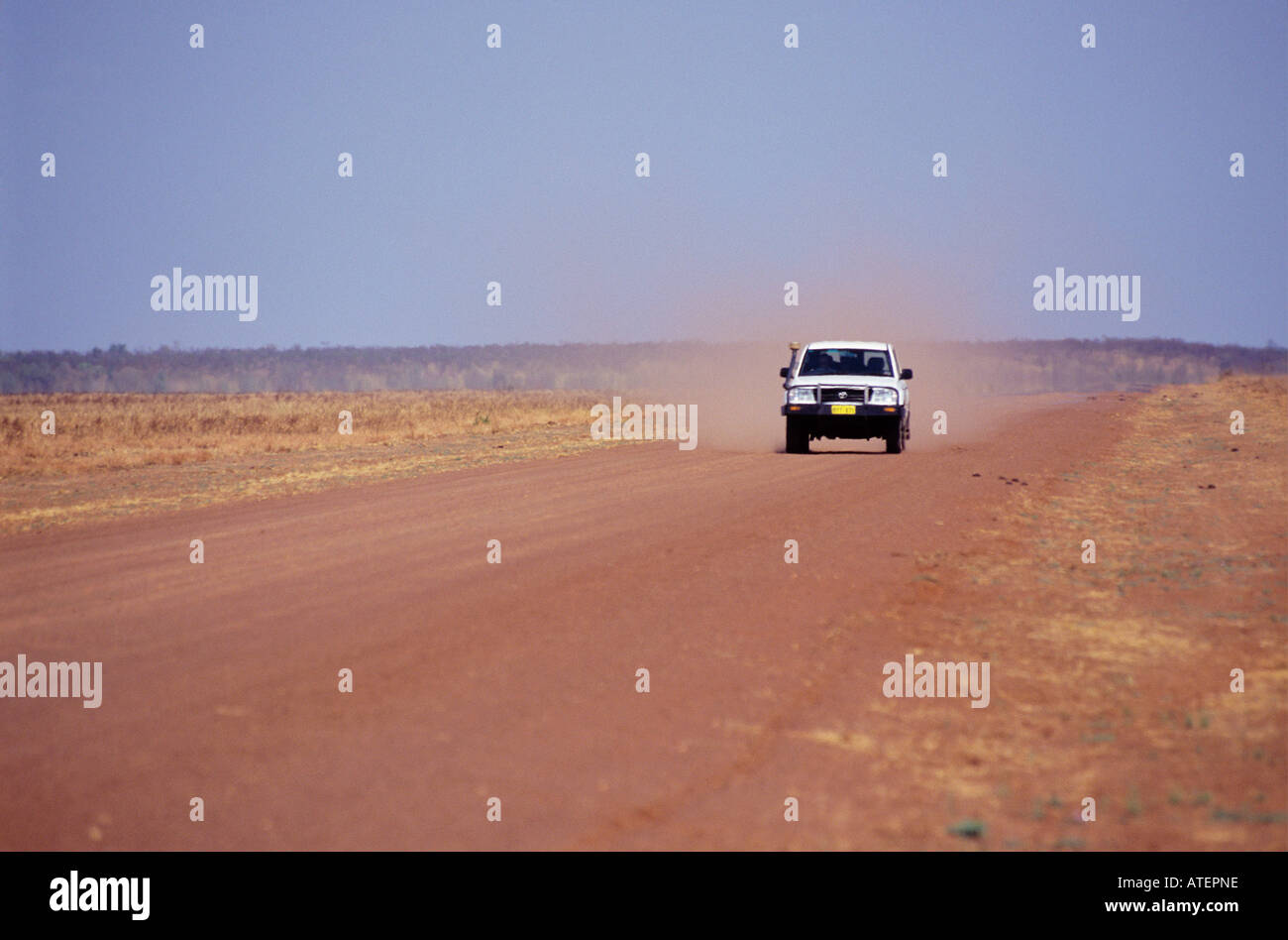 A four wheel drive motors along the plains billowing clouds of dust as ...