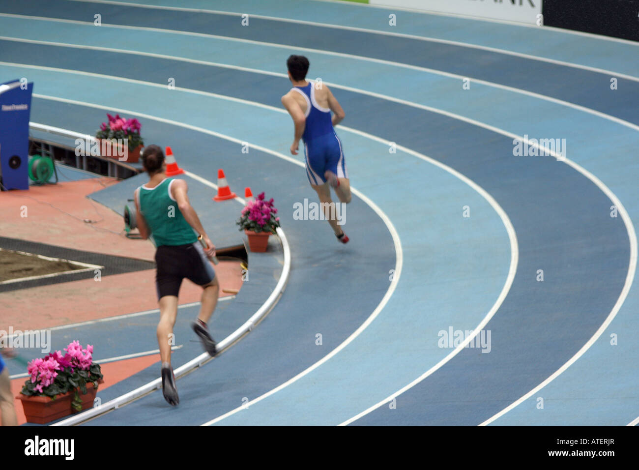 men indoors relay race sports and athletics concepts Stock Photo - Alamy