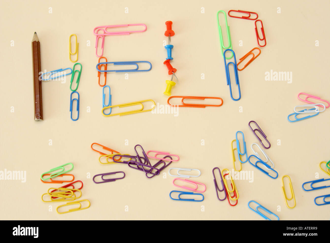 Office help sign in paper clips memo pins and pencil Stock Photo - Alamy