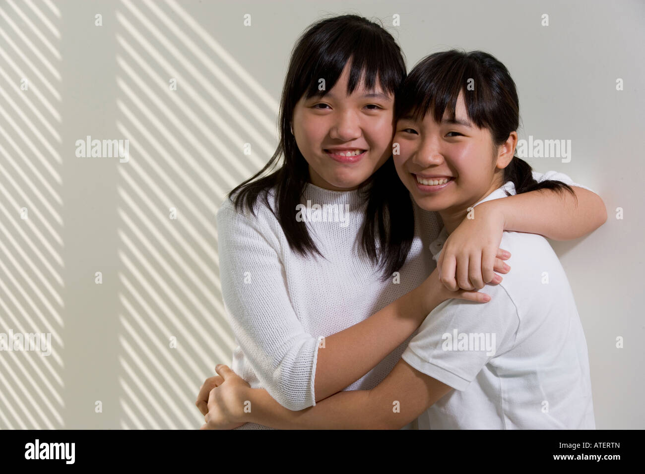Portrait of two sisters embracing each other Stock Photo - Alamy