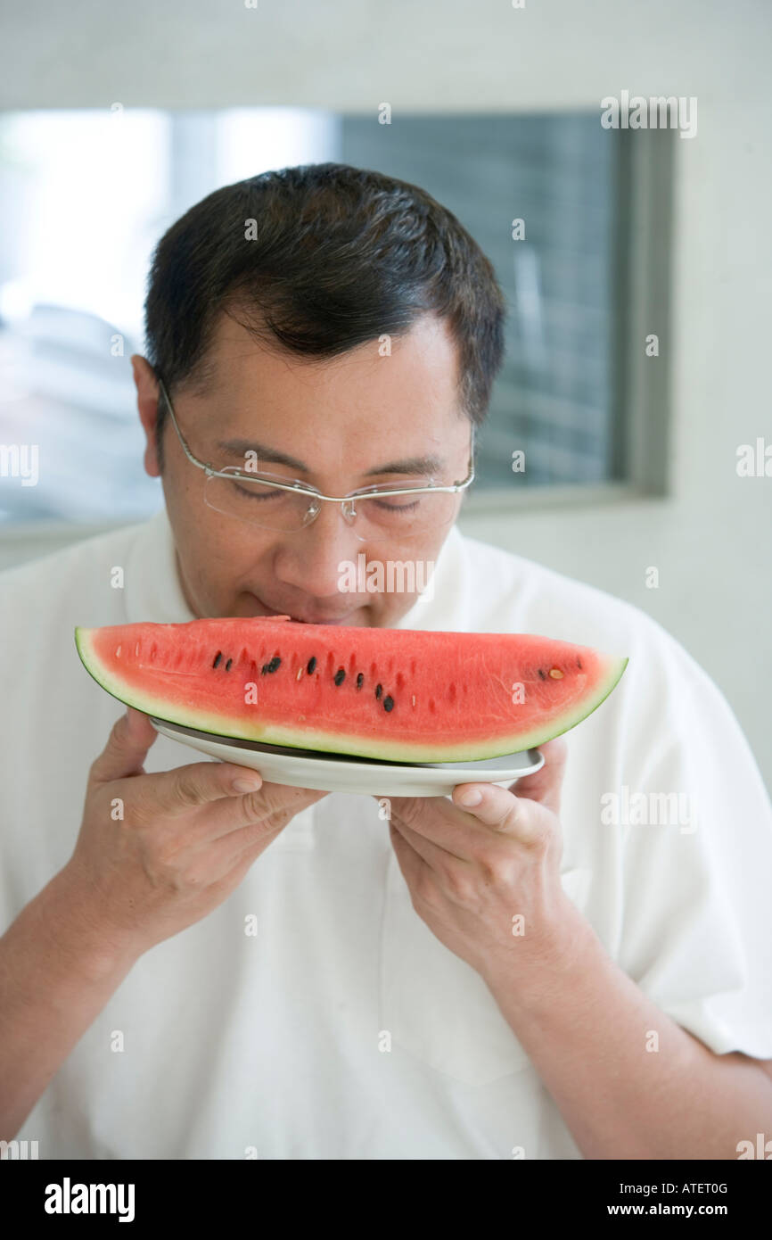 Asian man eating watermelon fruit hi-res stock photography and images ...