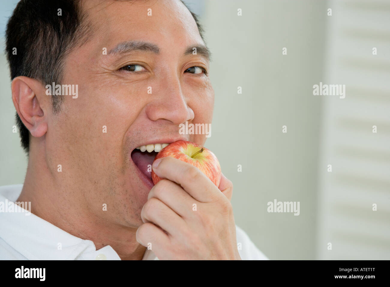 Portrait of a mature man eating an apple Stock Photo - Alamy