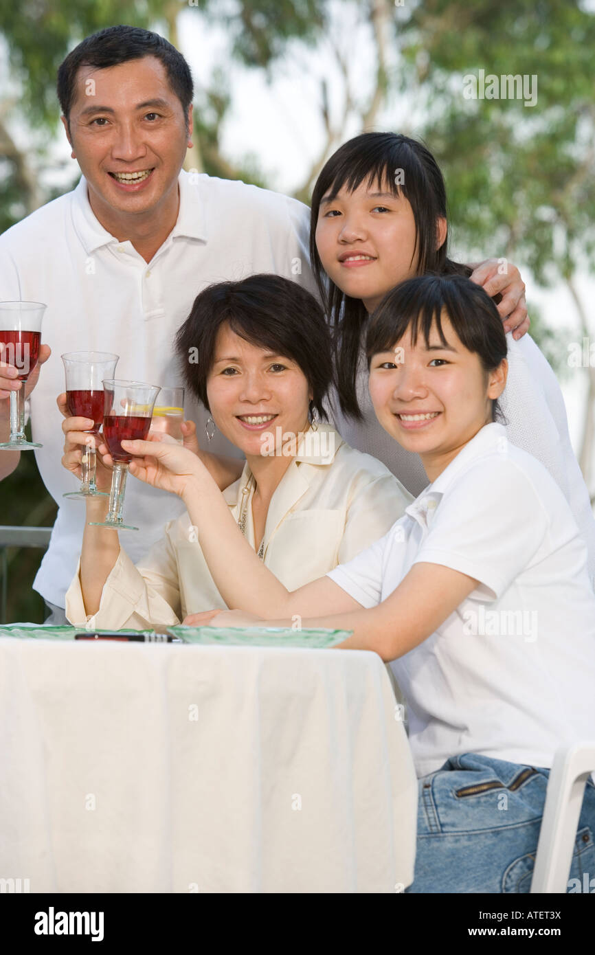 Portrait of parents and their two daughters toasting with wine Stock ...