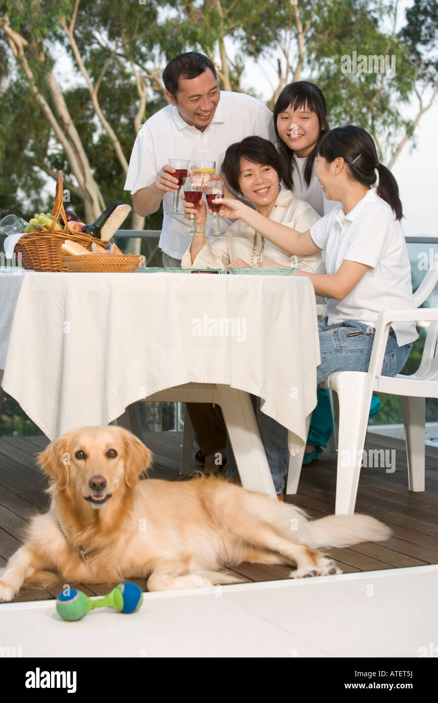 Parents and their two daughters toasting with wine Stock Photo - Alamy