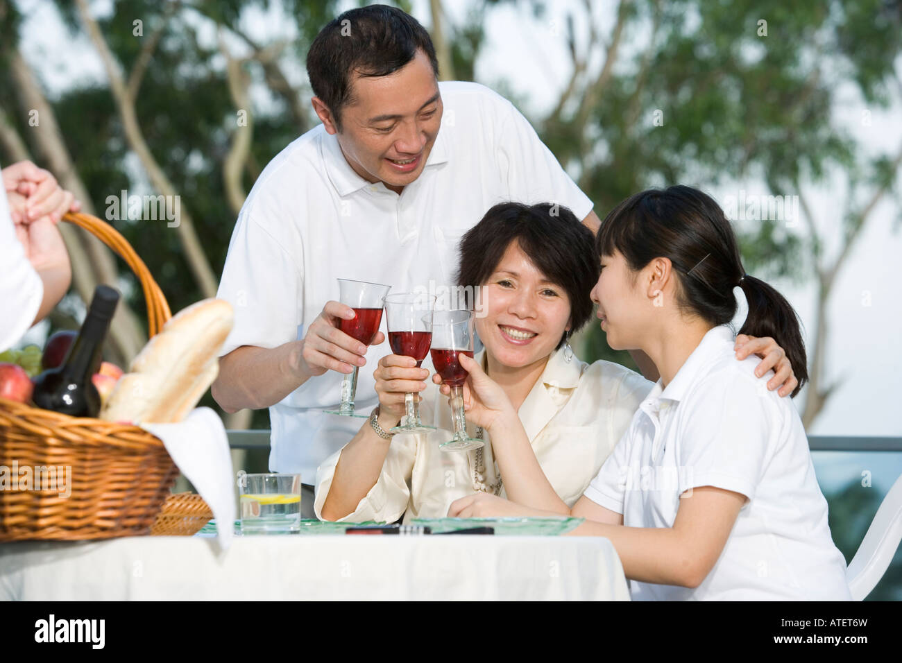 High angle view of parents and their two daughters toasting with wine ...