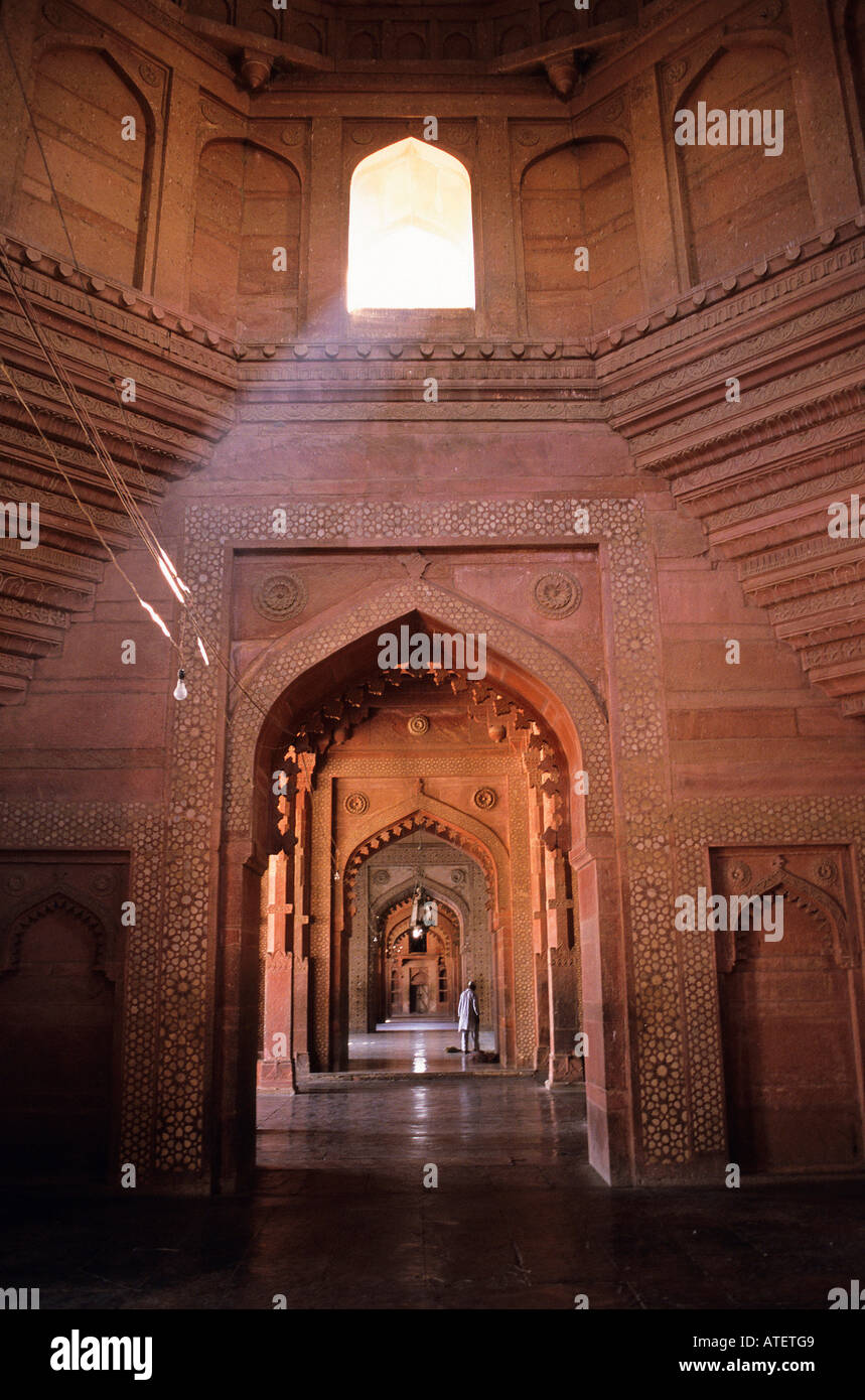 Sunshine streaming through a window a visitor looks around the interior ...