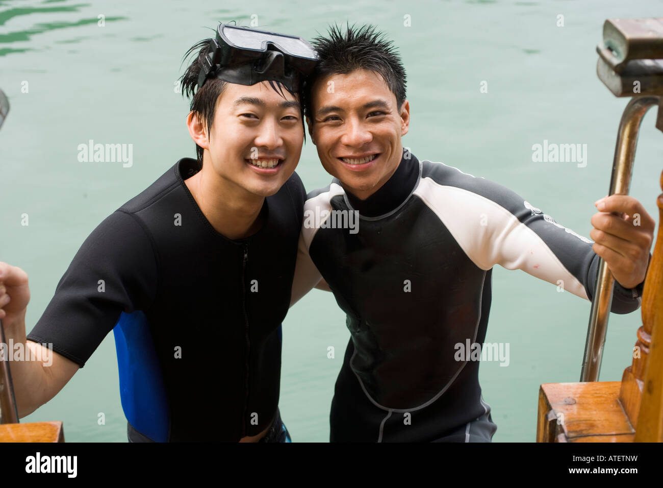 Portrait of two young men smiling Stock Photo - Alamy