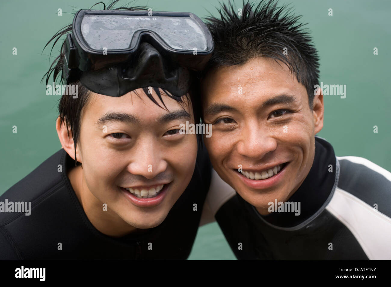 Portrait of two young men smiling Stock Photo - Alamy