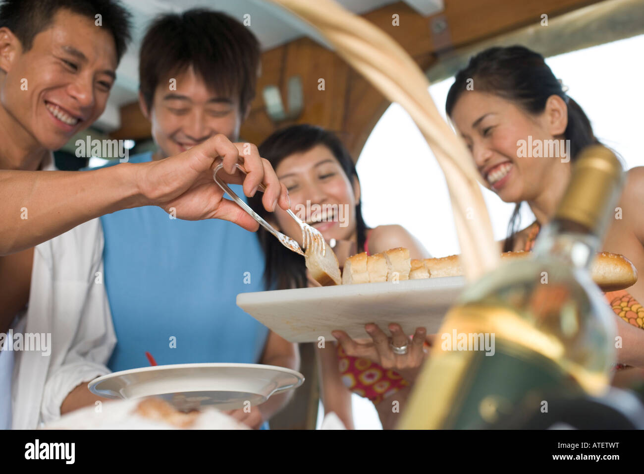 Low angle view of two young couples eating Stock Photo - Alamy