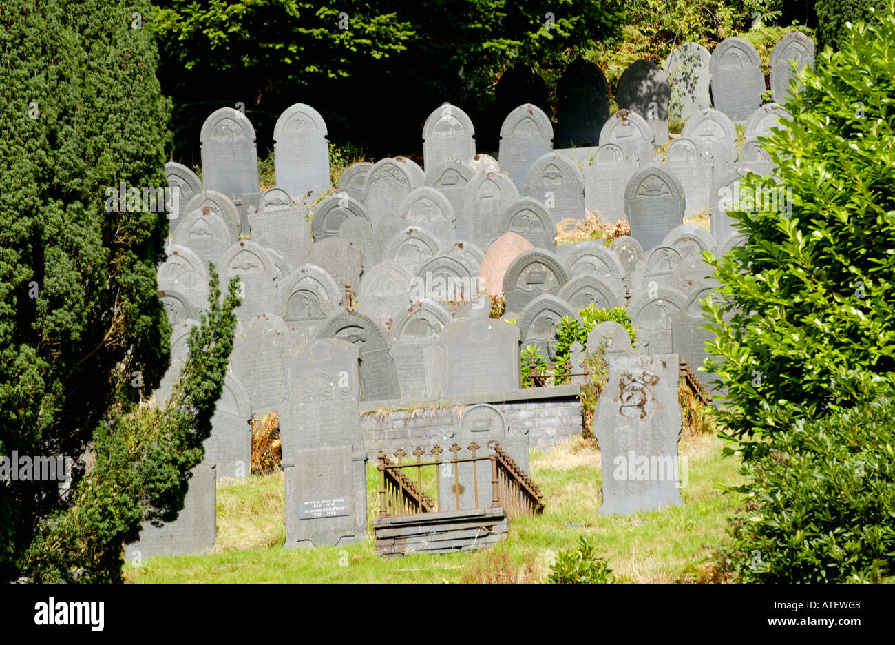 Graveyard with grey slate gravestones in former slate industry village ...