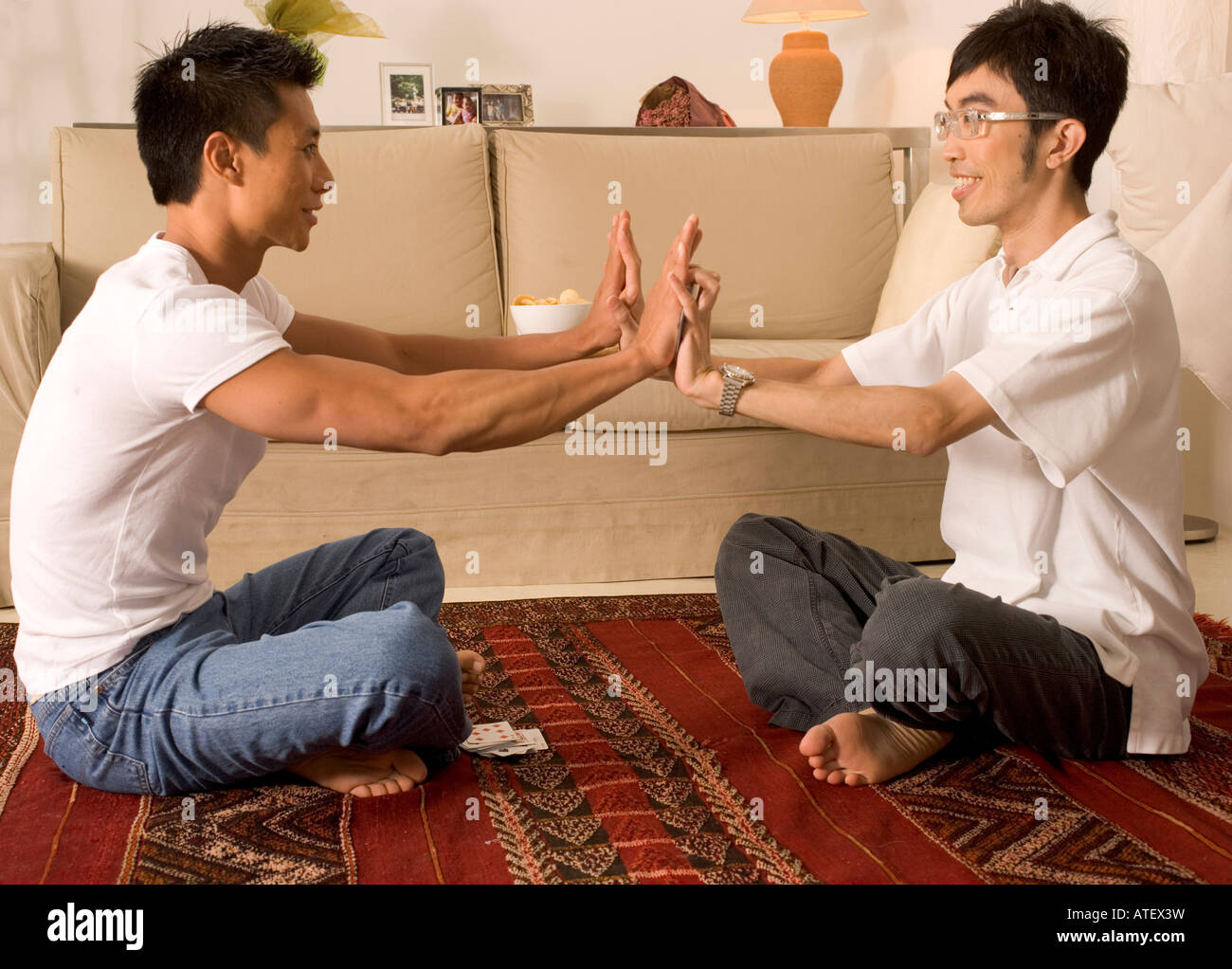 Side profile of two young men giving high-five Stock Photo - Alamy