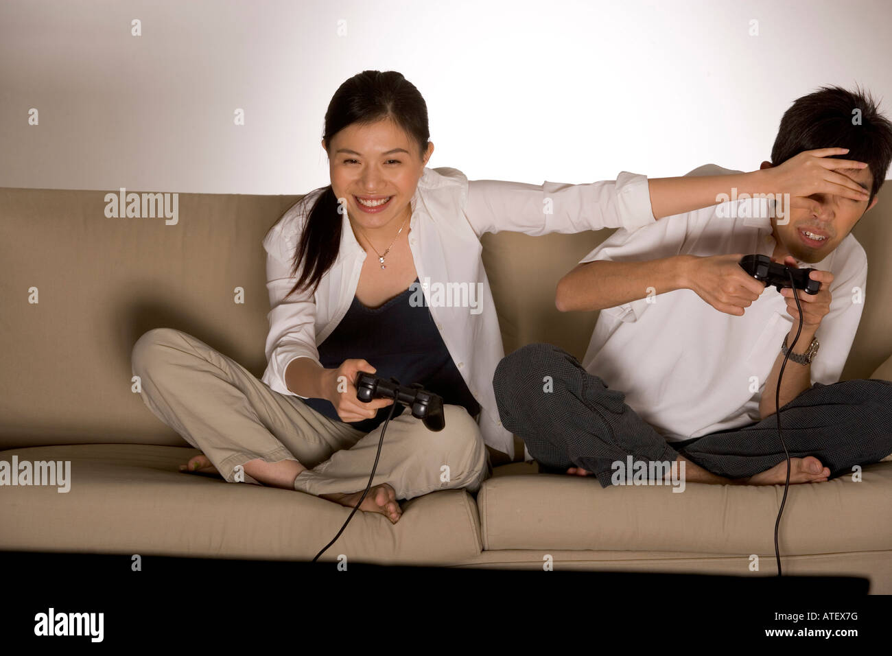Young couple playing video games Stock Photo - Alamy