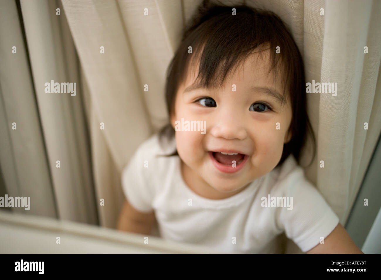 Young girl looking out window Stock Photo - Alamy