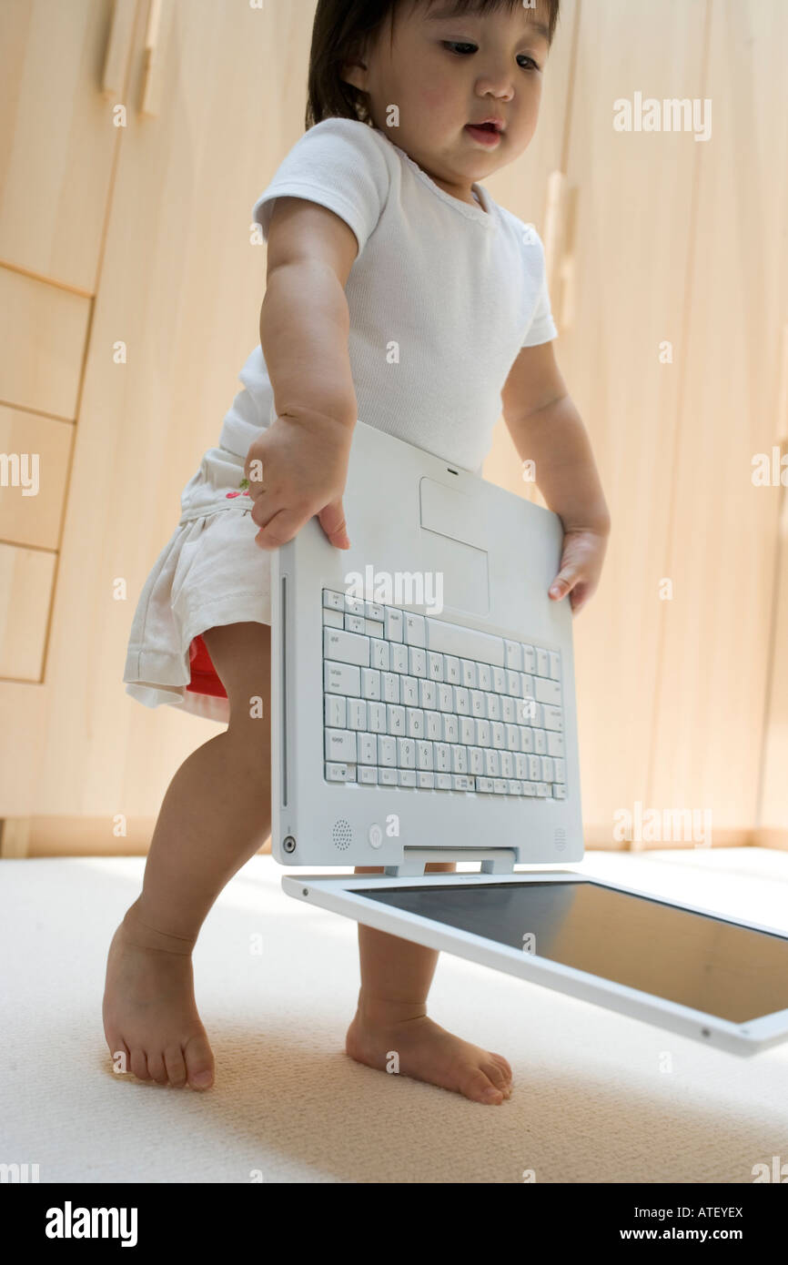 Young girl moving laptop Stock Photo - Alamy