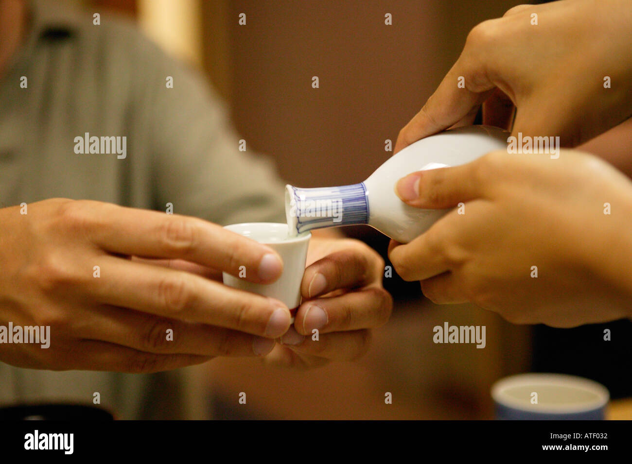 Woman serving sake Tokyo Japan Stock Photo - Alamy
