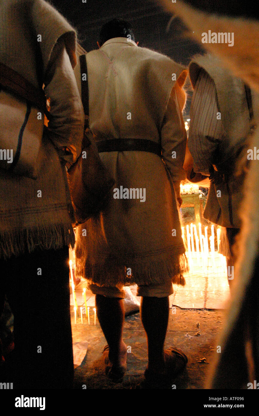 Indigenous men in prayer inside the church San Juan Chamula Mexico ...