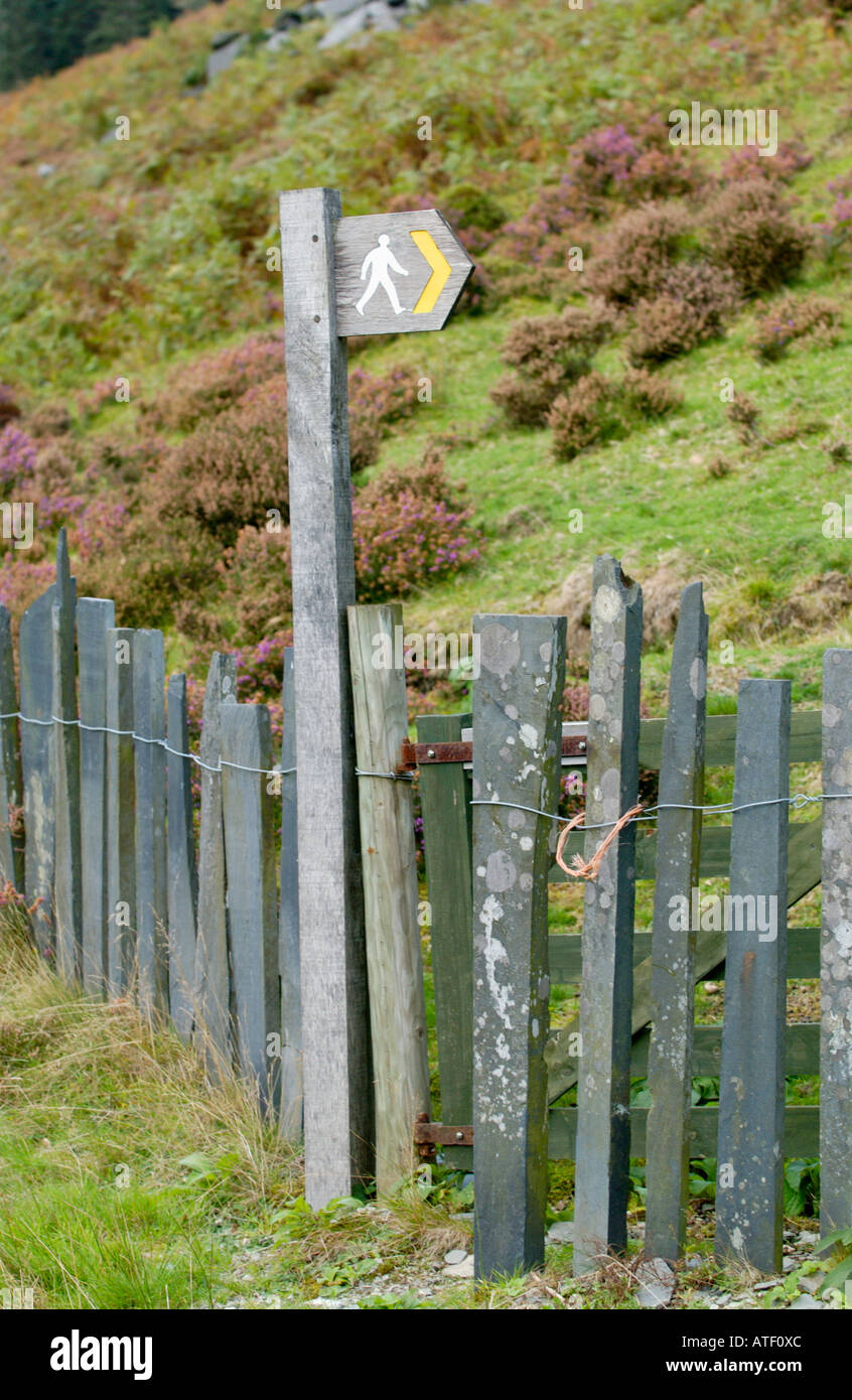 Traditional slate fence of the district with signpost on farmland ...