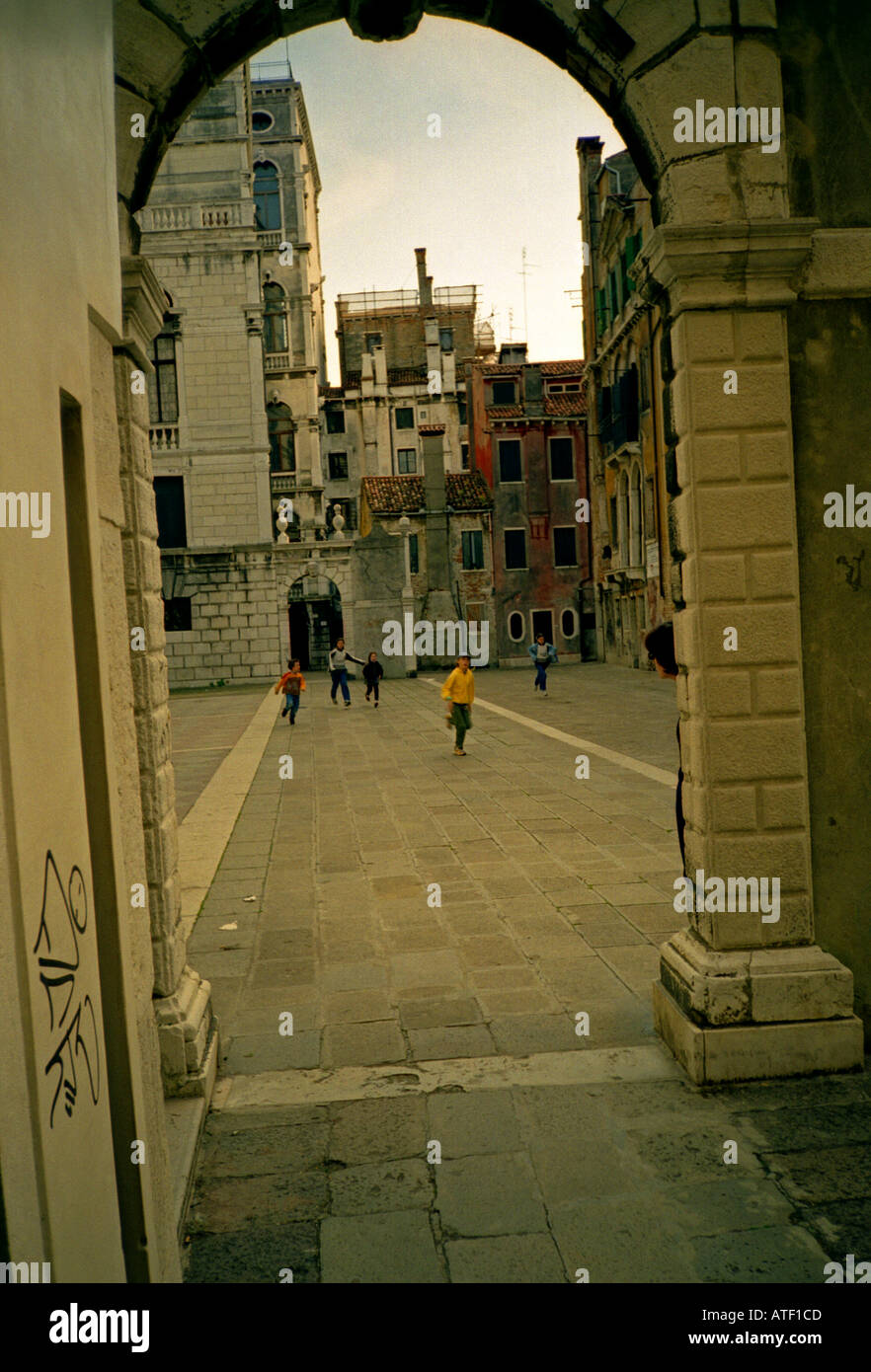 Venetian streetscape with children playing & running seen through an ...