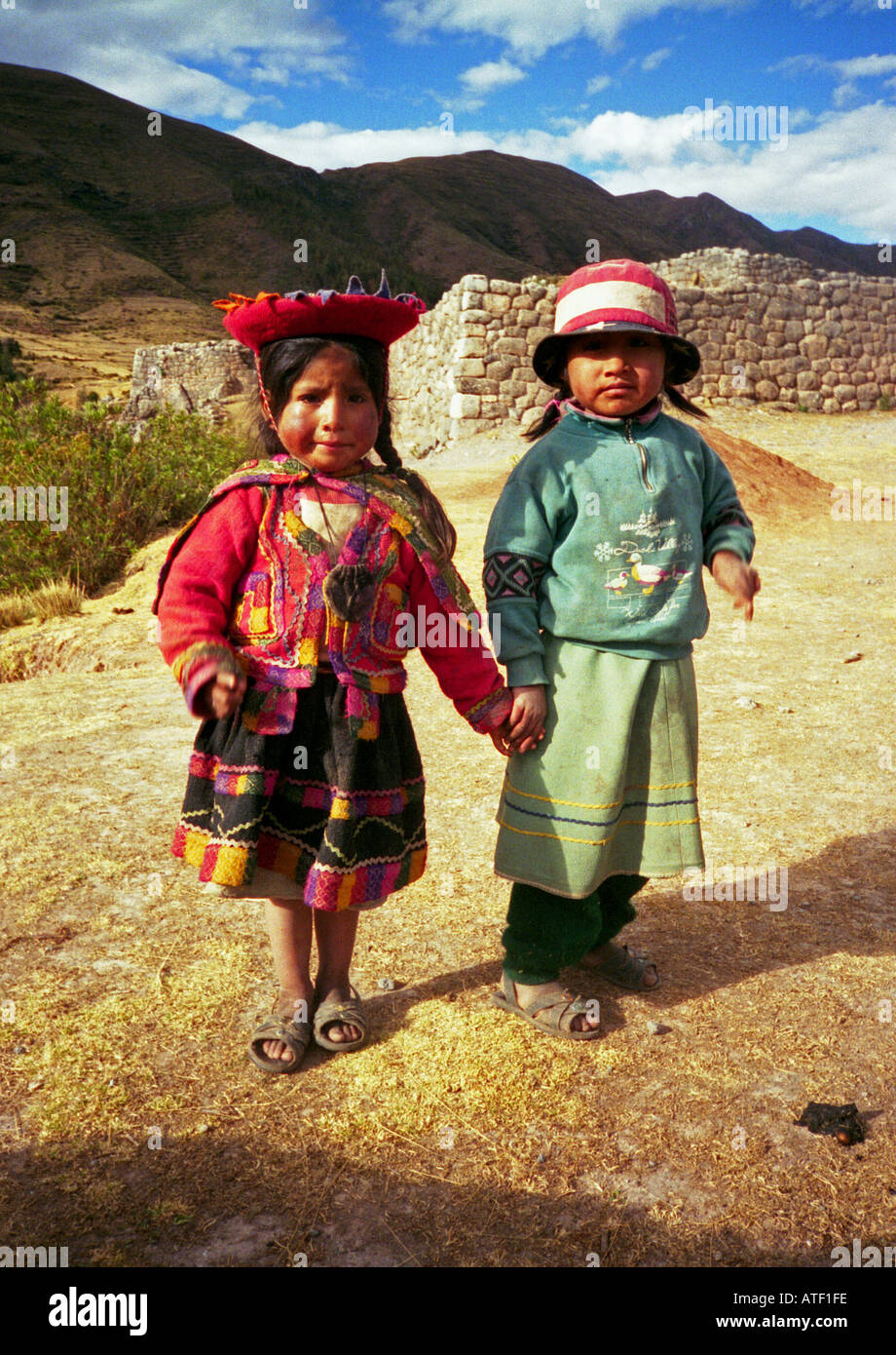 Portrait pair indigenous girl traditional colourful dress hat hold hand ...