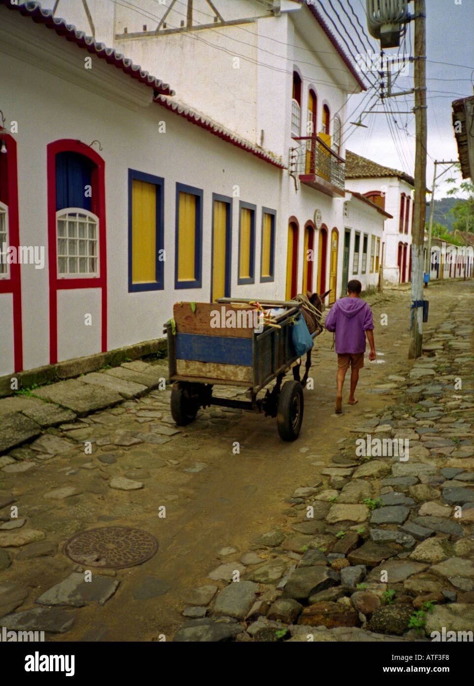 "Keep on Going" Man mule wheel pushcart walk carry fruit colonial town ...