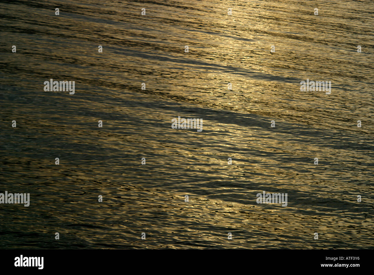 Sun reflecting off water surface Stock Photo - Alamy