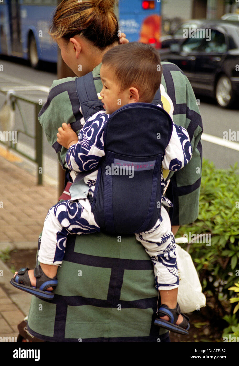 Portrait woman pride outdoor city street carry boy shoulder hold hug ...