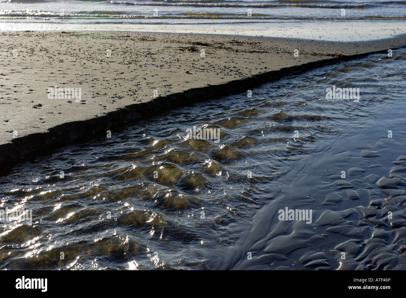 Rill flowing into the sea Stock Photo - Alamy