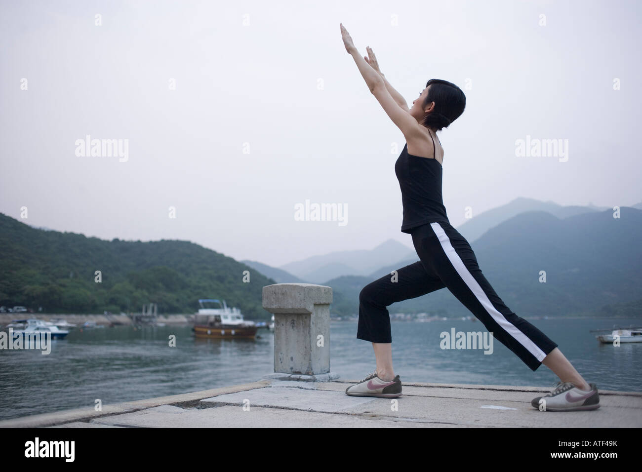 Side profile of a young woman stretching Stock Photo - Alamy
