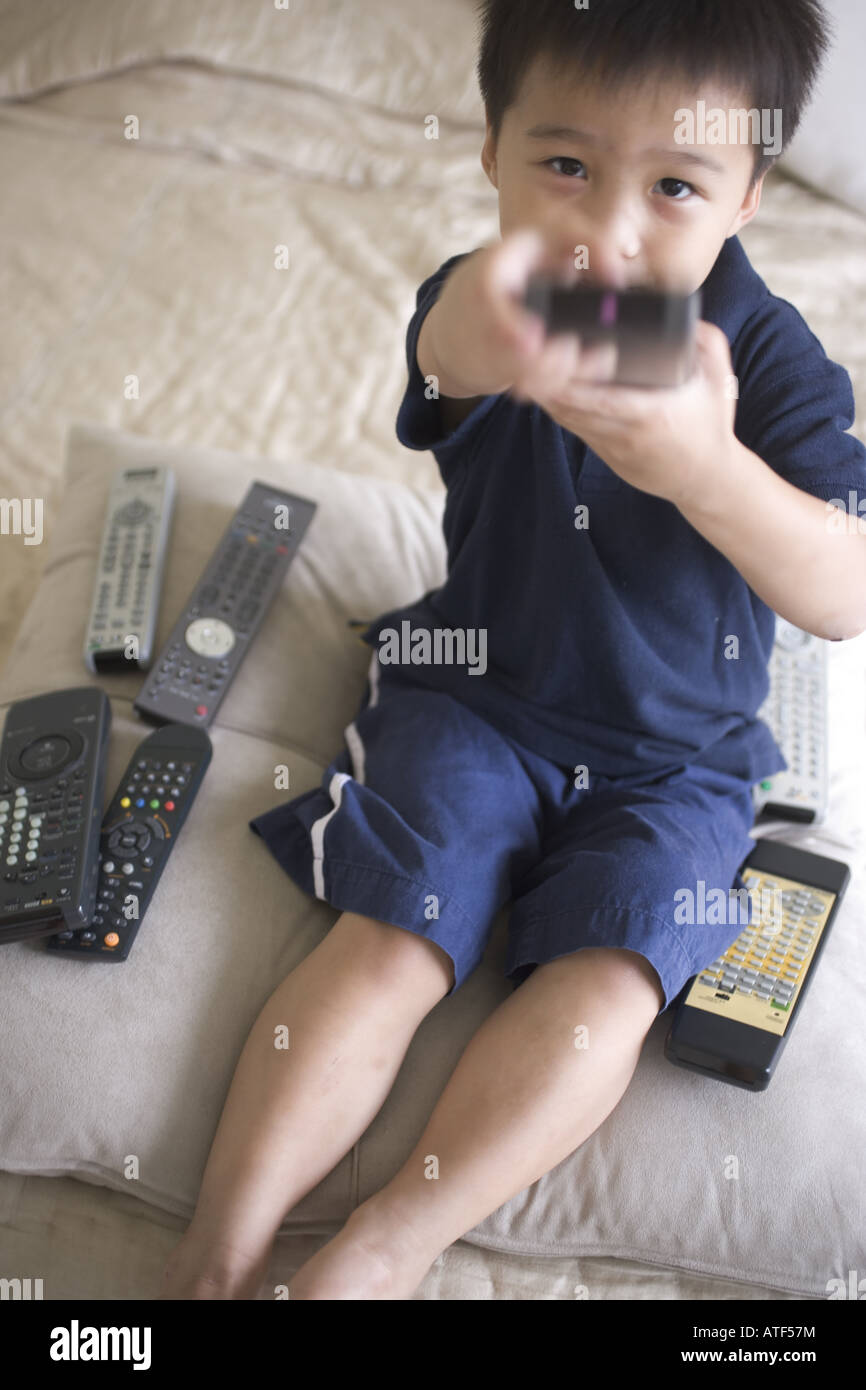 Boy changing TV channels Stock Photo - Alamy
