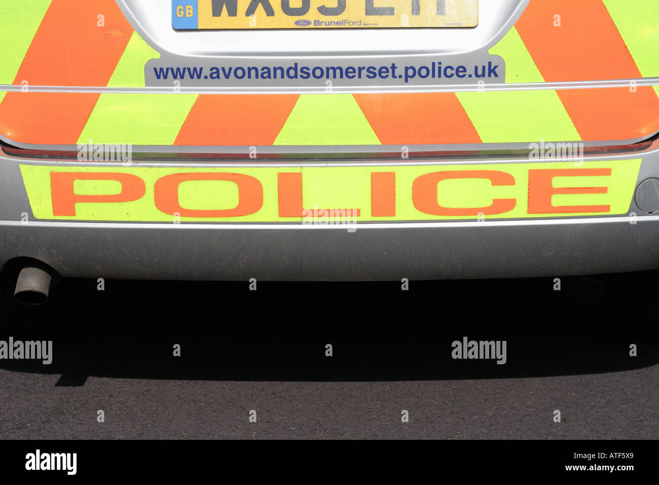 Police car with high visibility orange yellow markings Stock Photo - Alamy