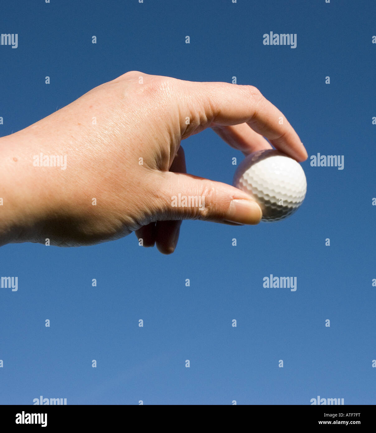 Golf ball held by hand Stock Photo - Alamy
