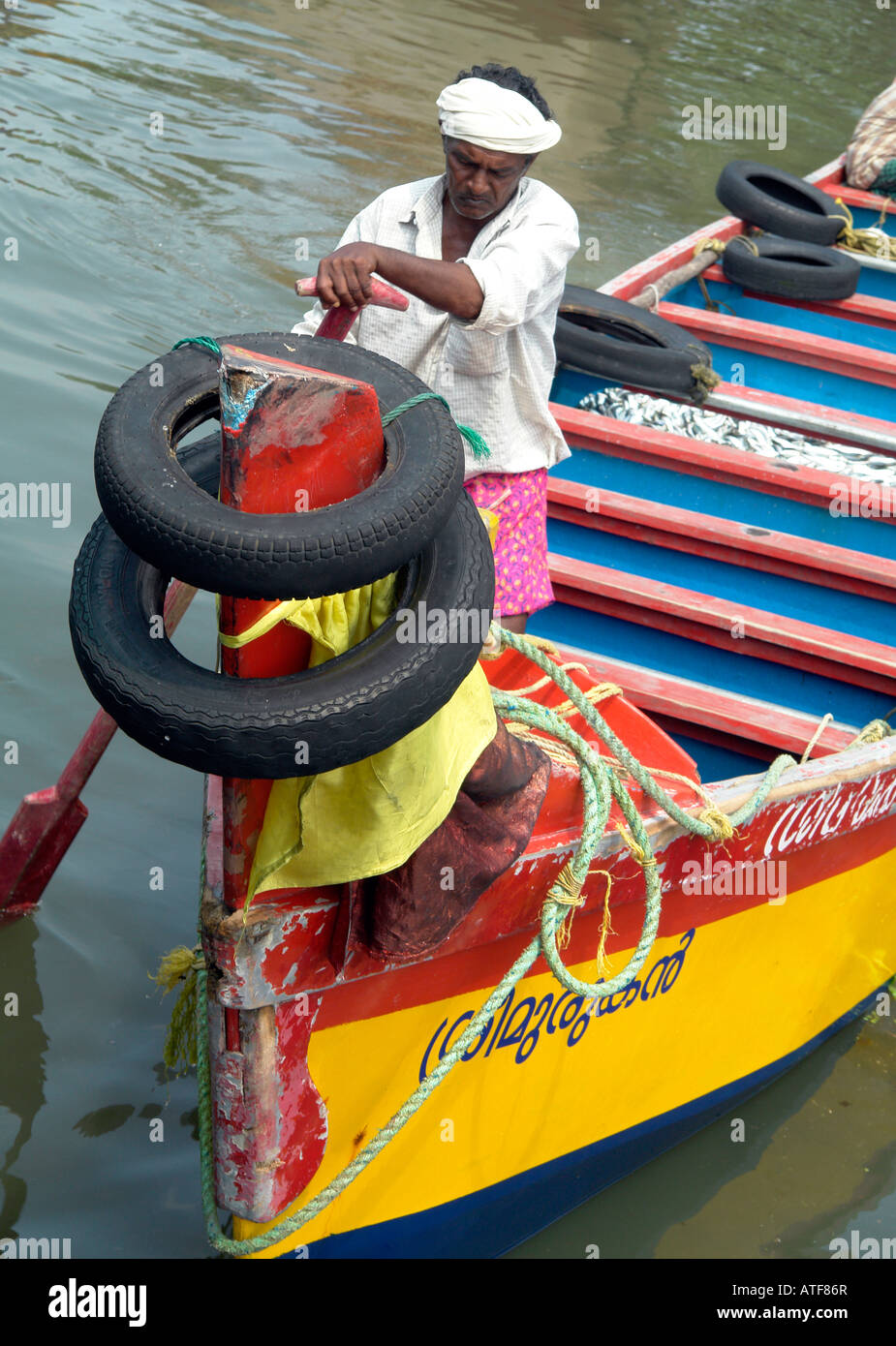 local indian boatman at the fish market on the kerala backwaters south ...