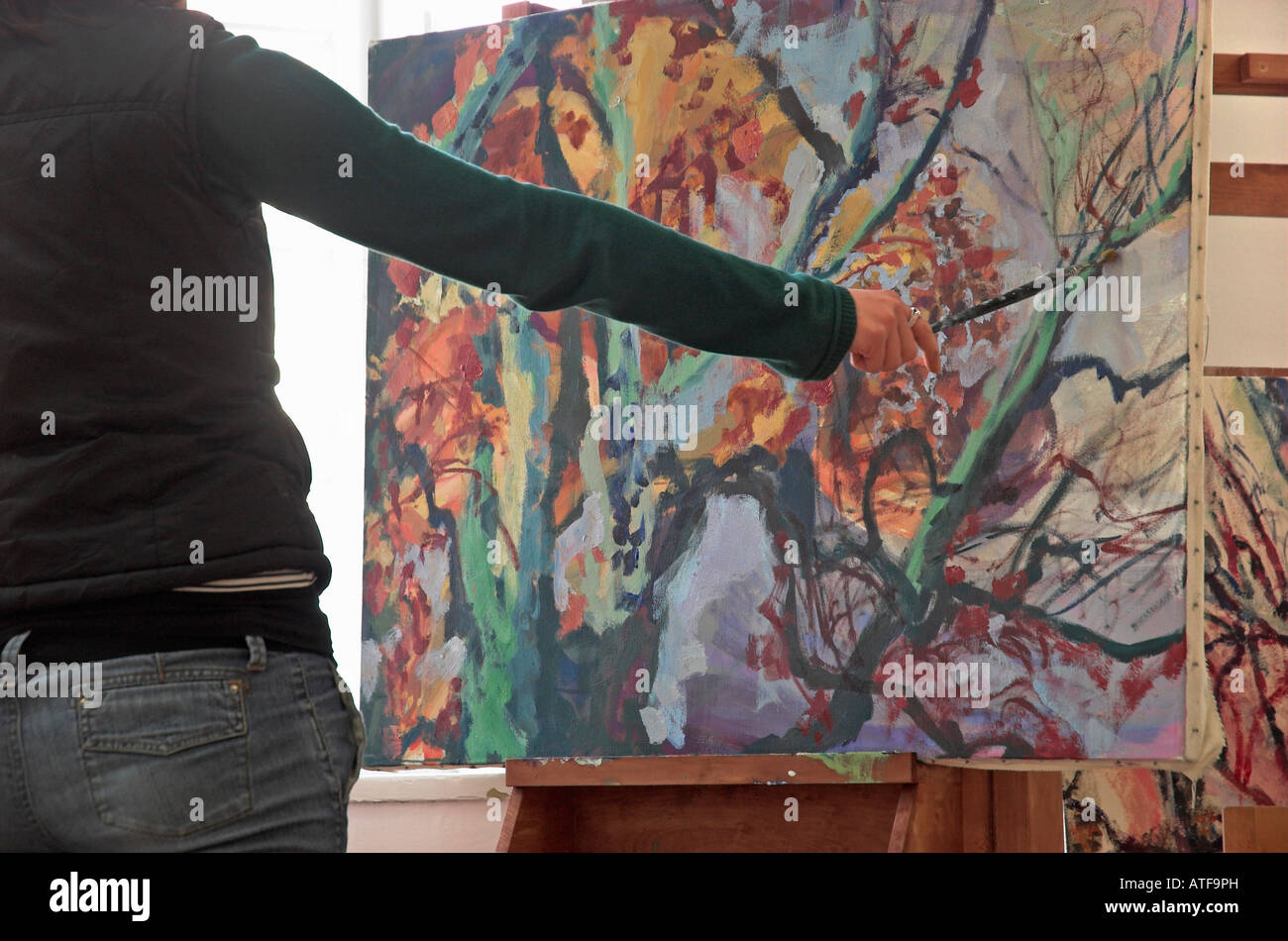 Young female art student painting Stock Photo - Alamy