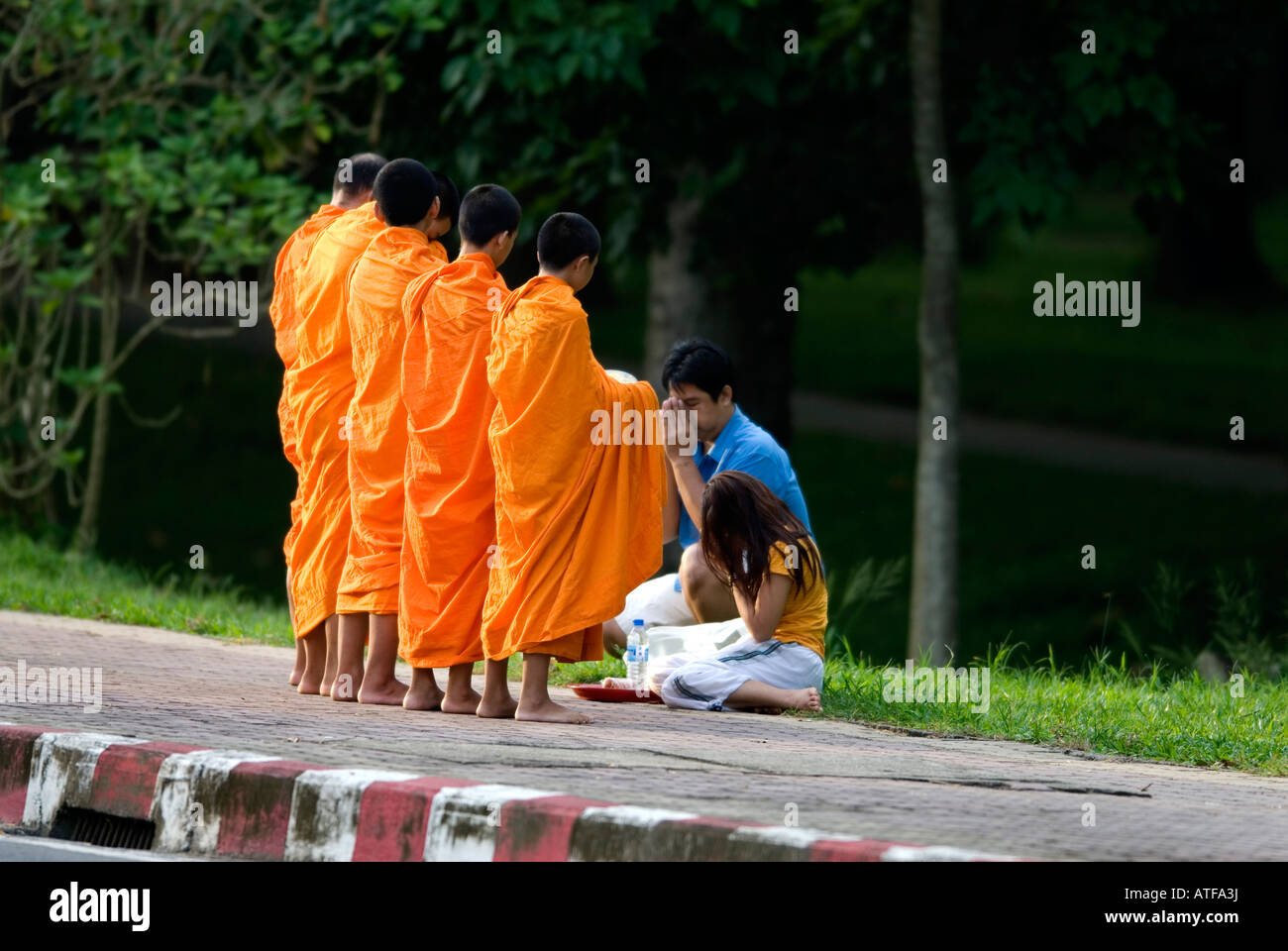 Thai people paying respect to Buddhist monks and giving alms Stock ...