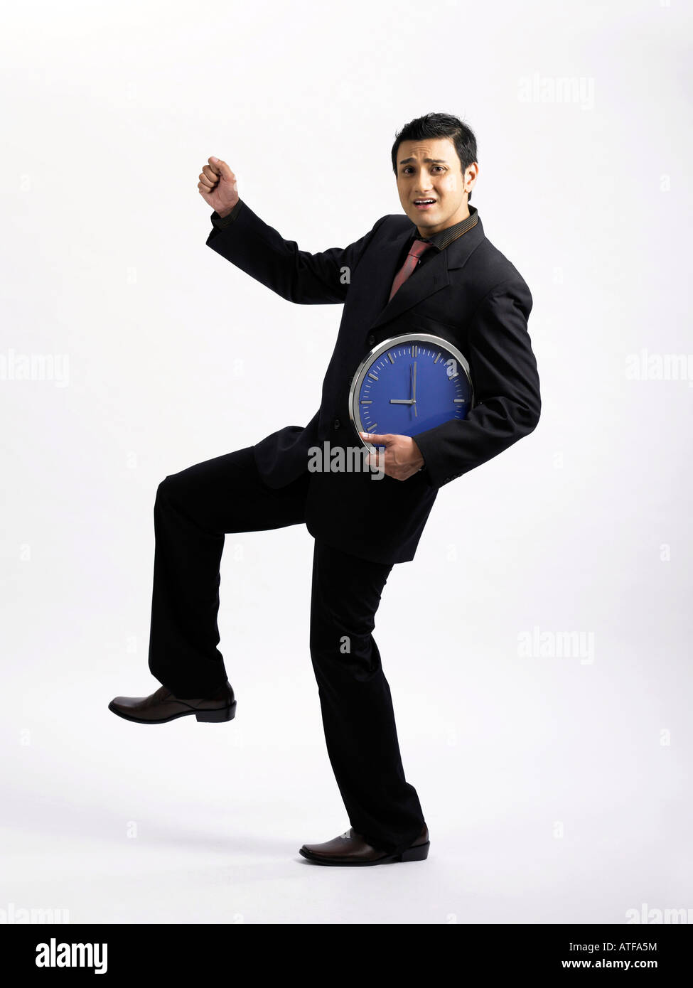 businessman running with a clock Stock Photo - Alamy
