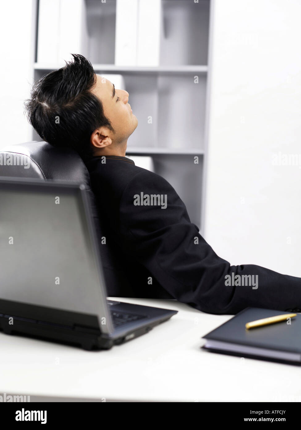 a tired businessman resting on the chair Stock Photo - Alamy