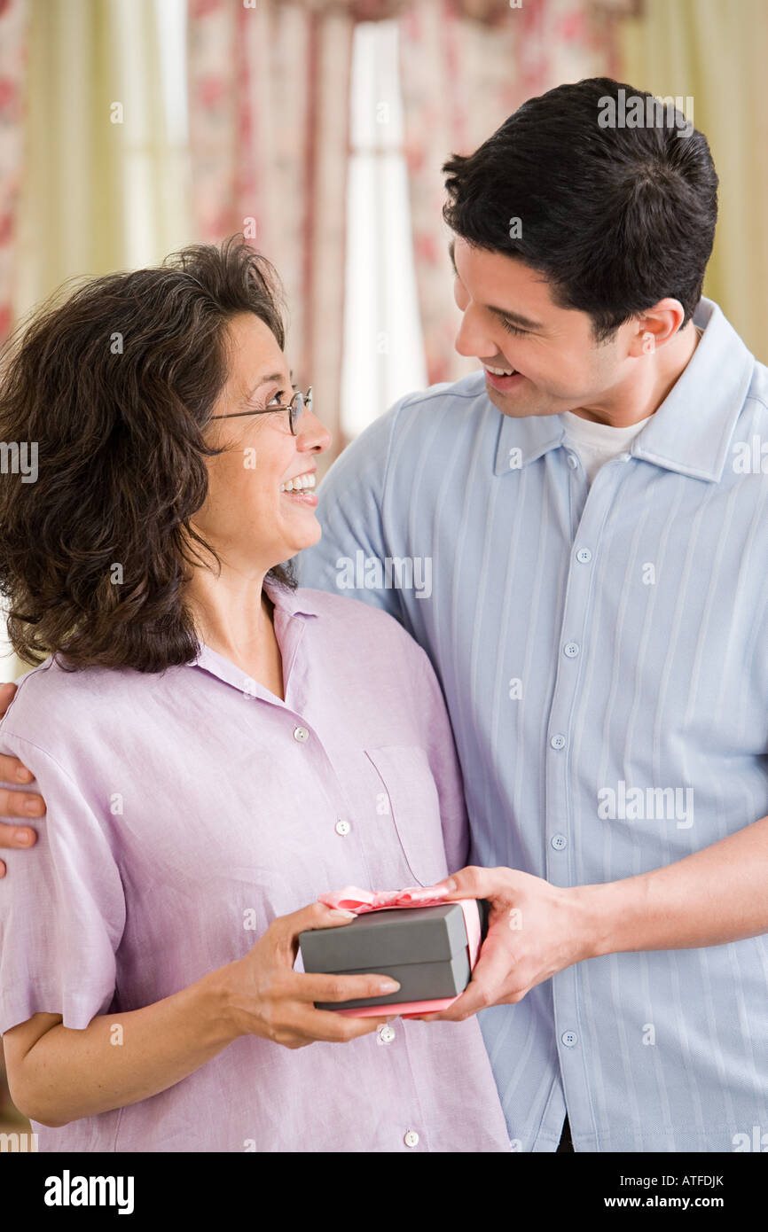 Man with gift for mother Stock Photo - Alamy