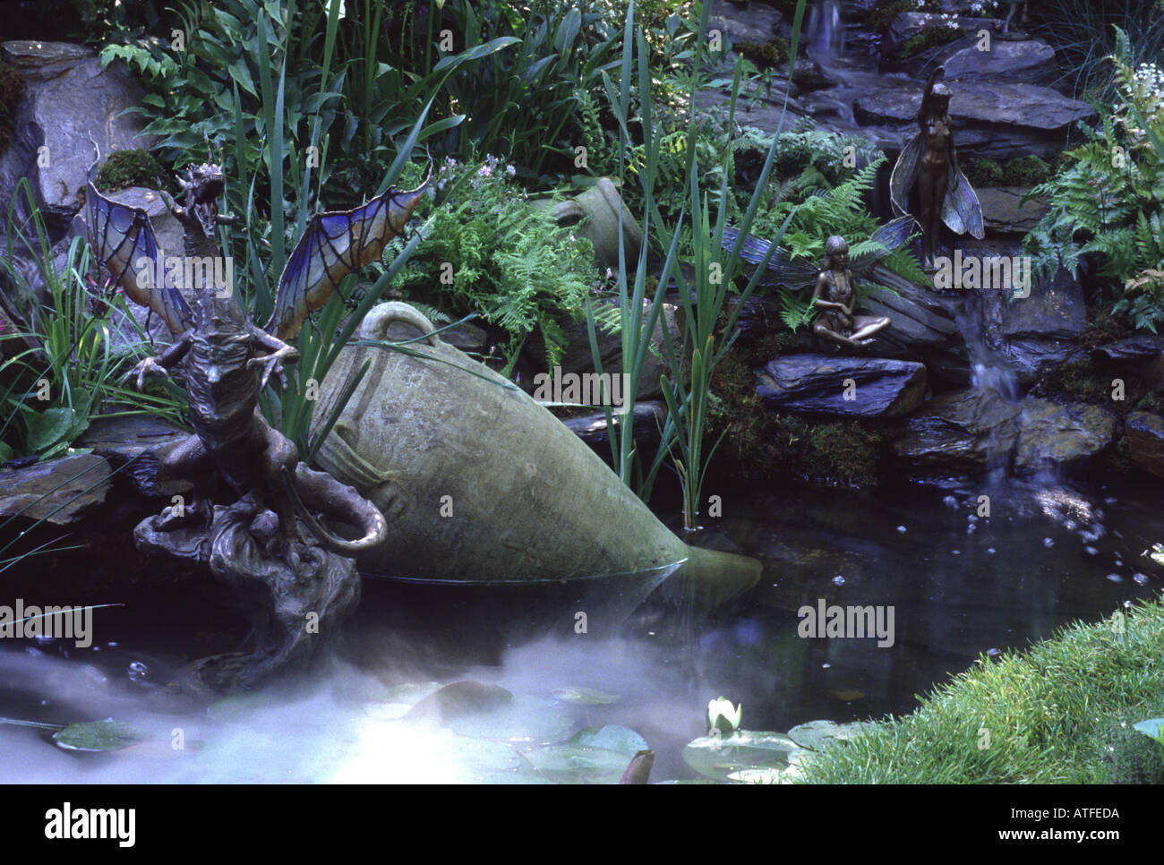 Ornamental mythical statue of dragon around garden pool Chelsea Fower ...