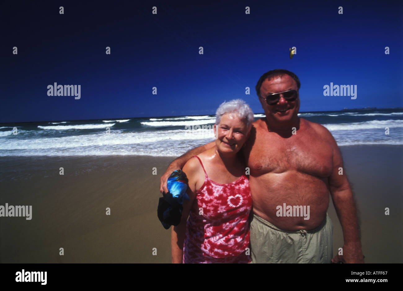 grey haired couple in love hugging on beach Maroochydore Queensland ...