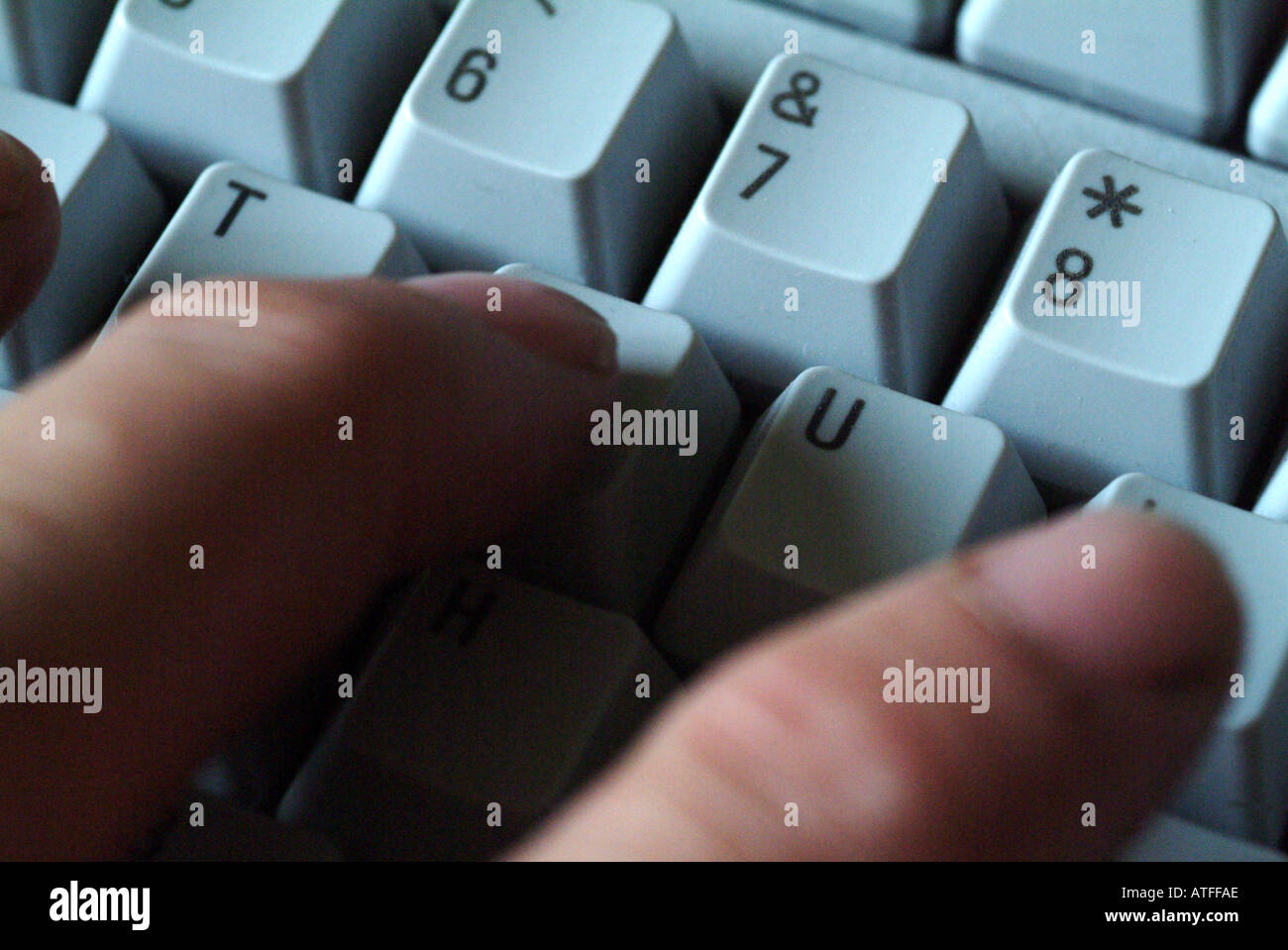 Finger depressing key on computer keyboard Stock Photo - Alamy