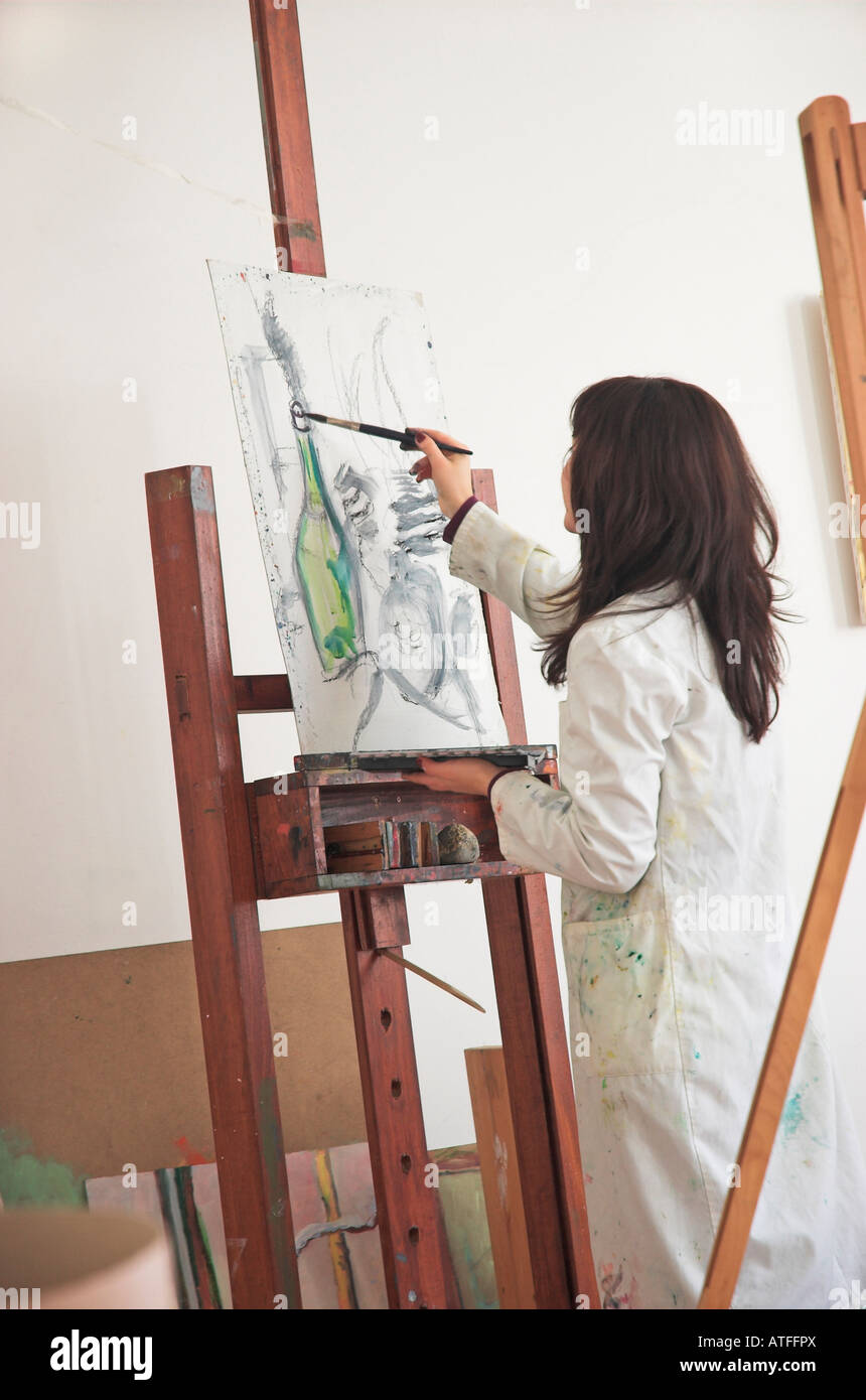 Young female art student painting Stock Photo - Alamy