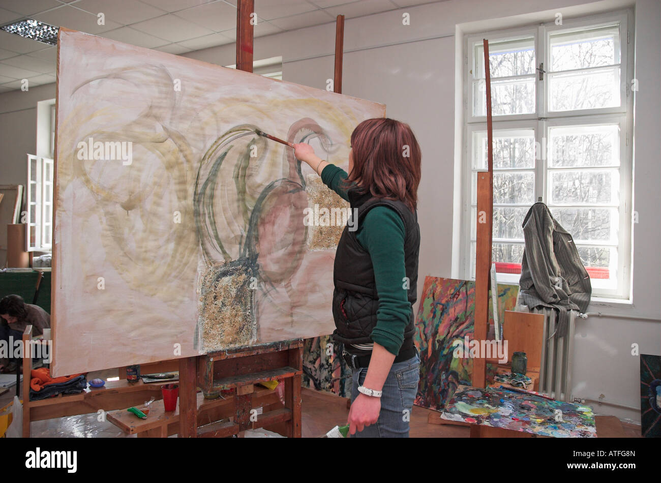Young female art student painting Stock Photo - Alamy