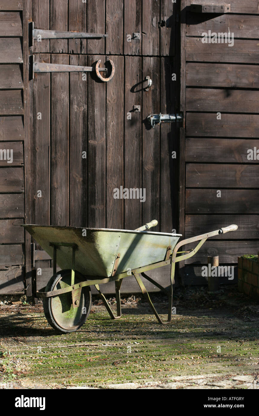 Old wheel barrow outside stable Stock Photo - Alamy