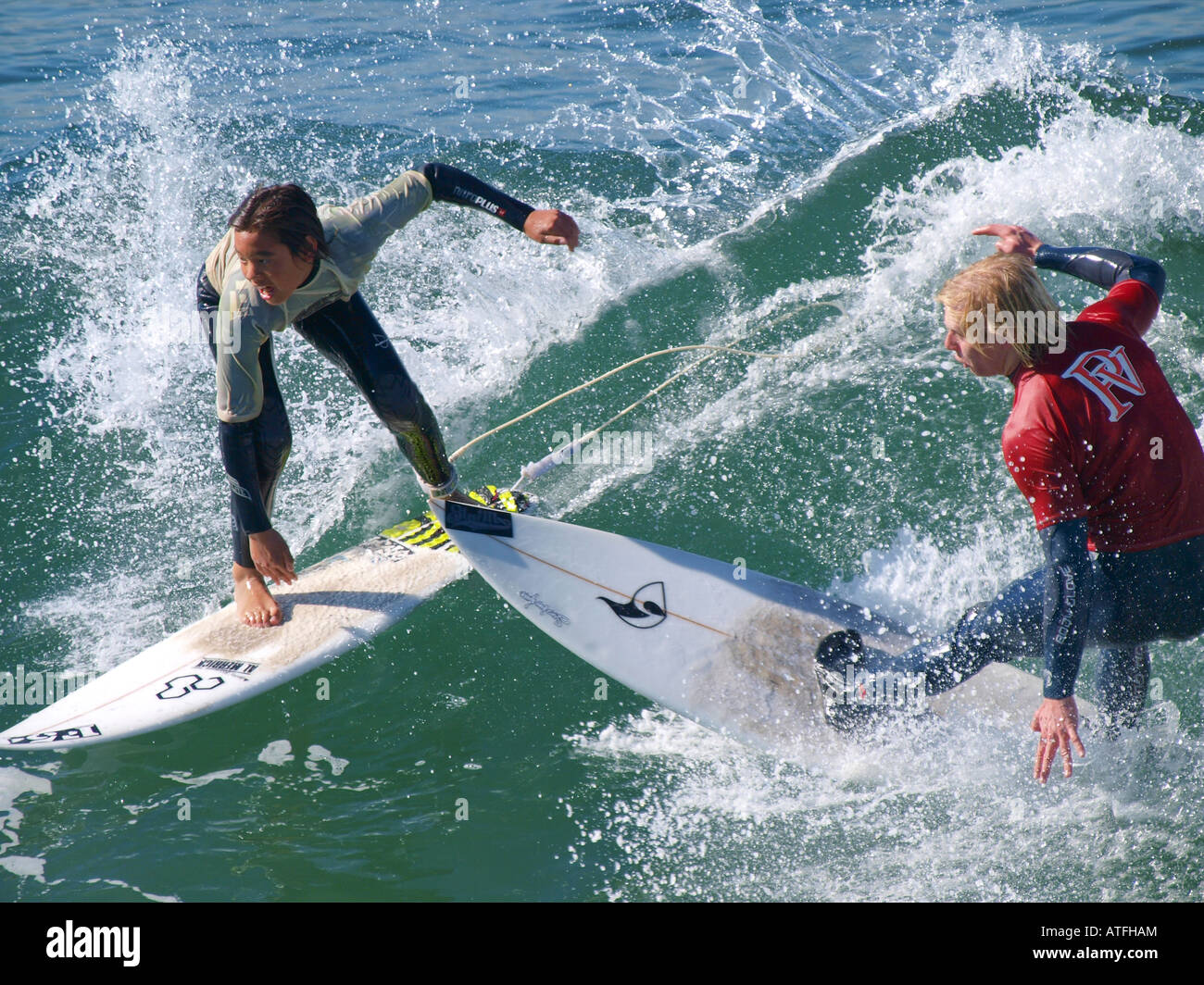 Two young surfers almost collide during surfing competition Stock Photo ...