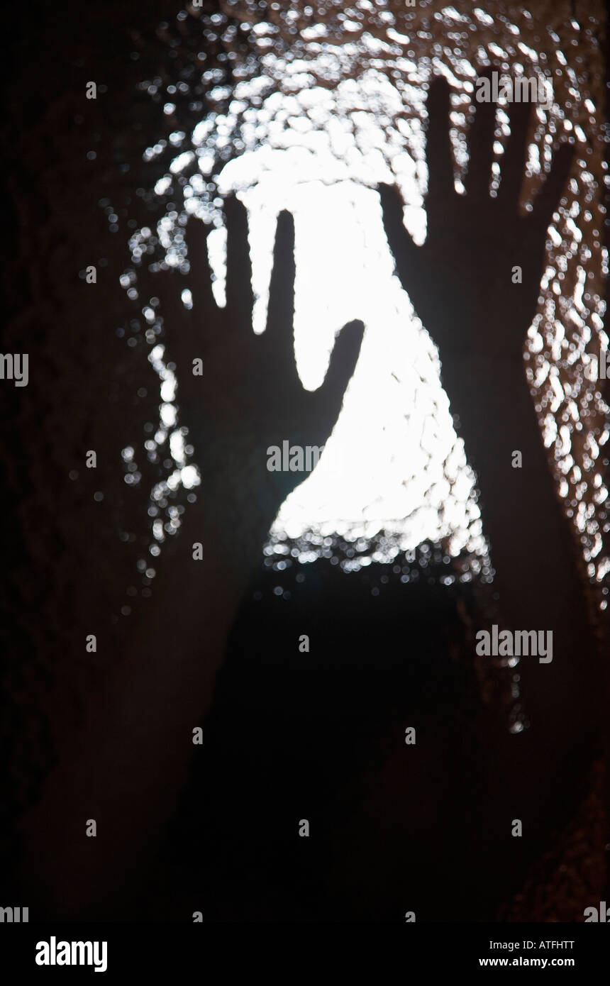 Woman placing hands on window Stock Photo - Alamy
